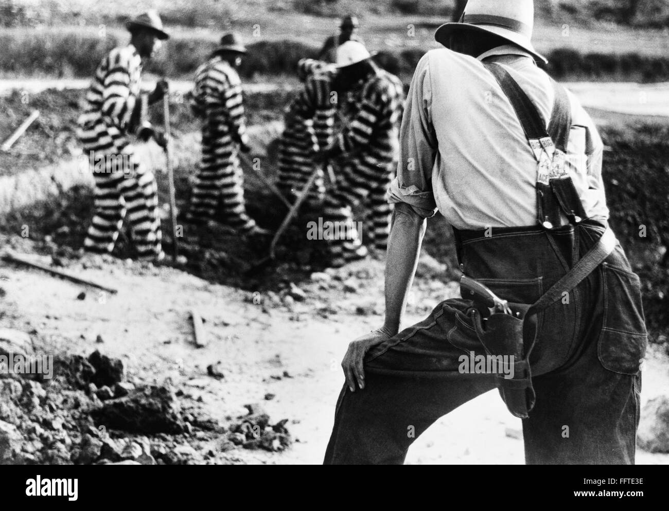 GEORGIA: PRISON GUARD, 1941. /nA prison guard watching convicts as they ...