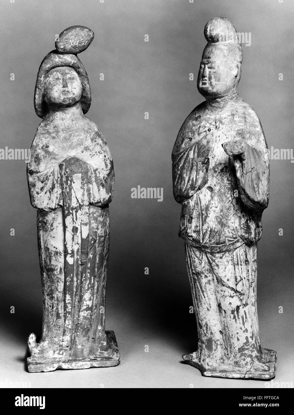 CHINA: TOMB FIGURES. /nRed clay tomb figures of a woman and a man, with ...