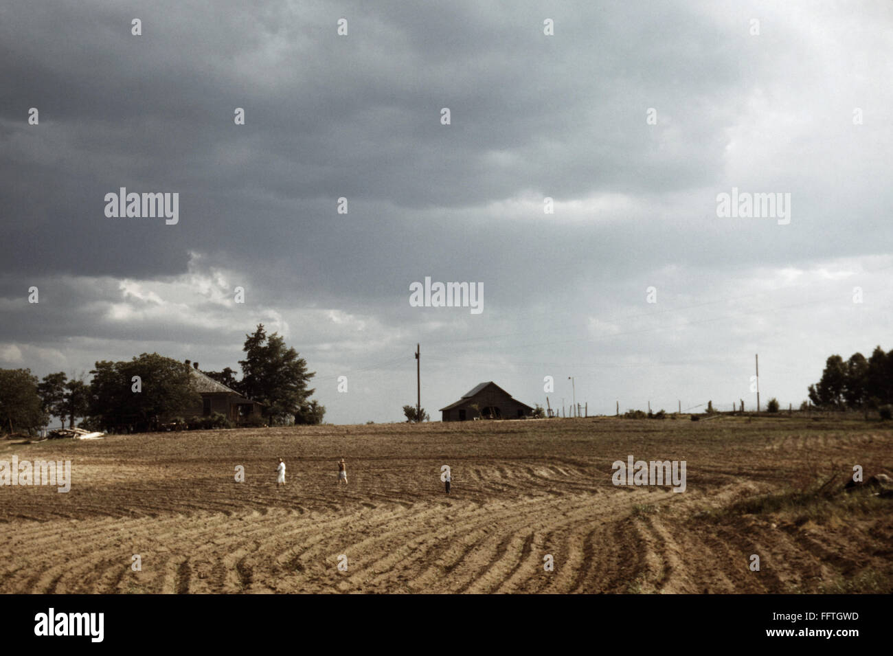 GEORGIA: COTTON FARM, 1941. /nCotton workers going home after an ...