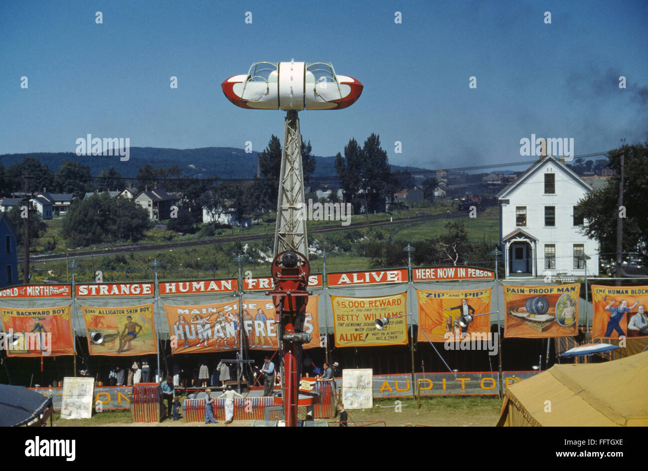 VERMONT STATE FAIR, 1941. /nSide show banners and rocket ride at the ...