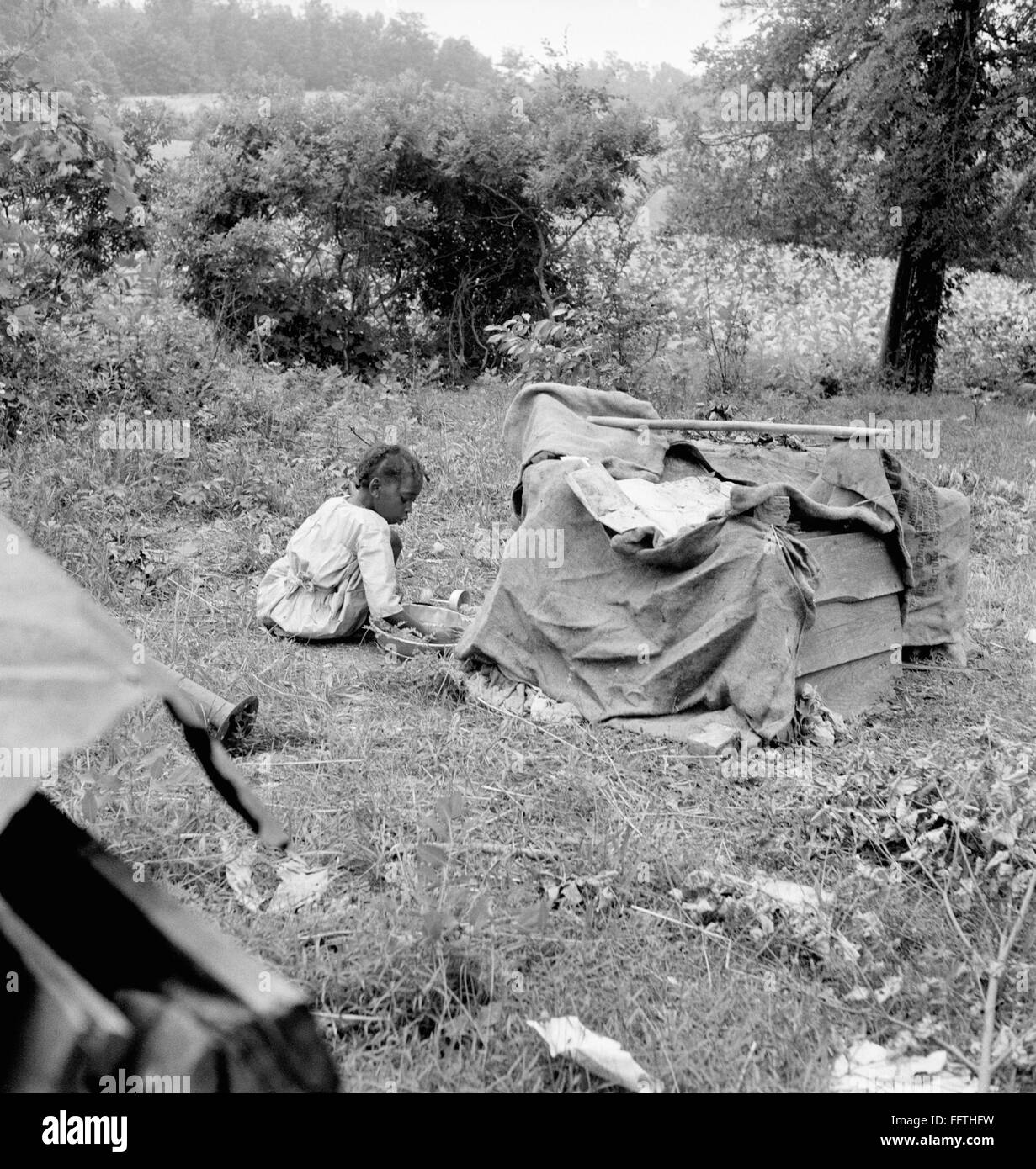 FARM CHILD, 1939. /nA tobacco sharecropper child playing with a burlap ...