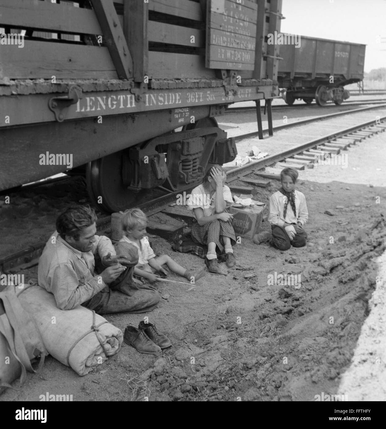 HOMELESS FAMILY, 1939. /nA destitute farmer with his family seated ...