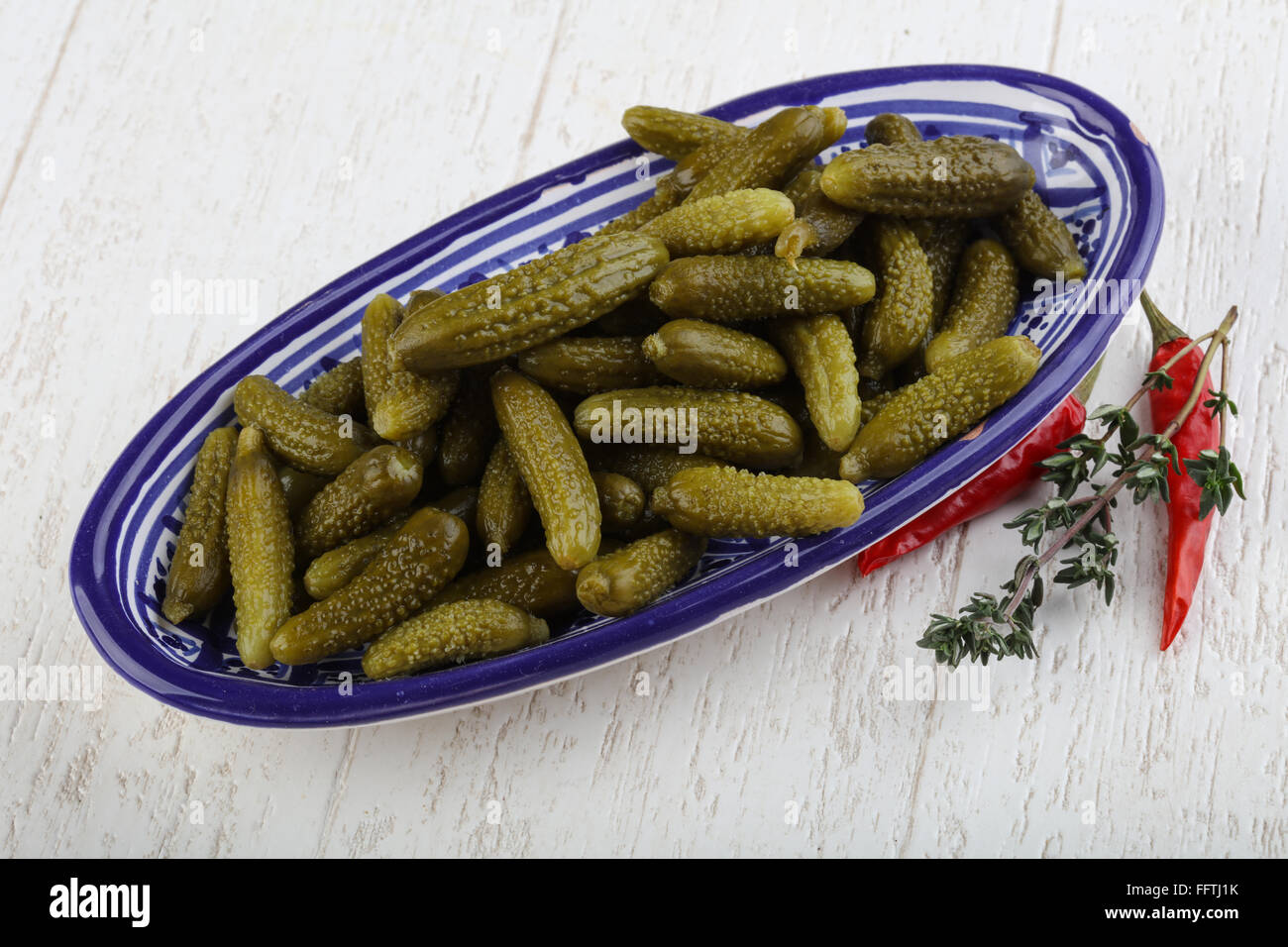 Small Pickled cucumbers on the wood background Stock Photo - Alamy
