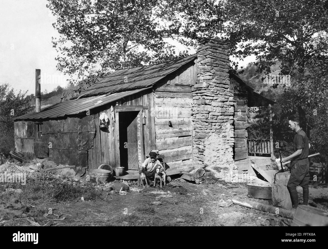 HINE: LOG CABIN, 1921. /nA small run-down log cabin occupied by a ...