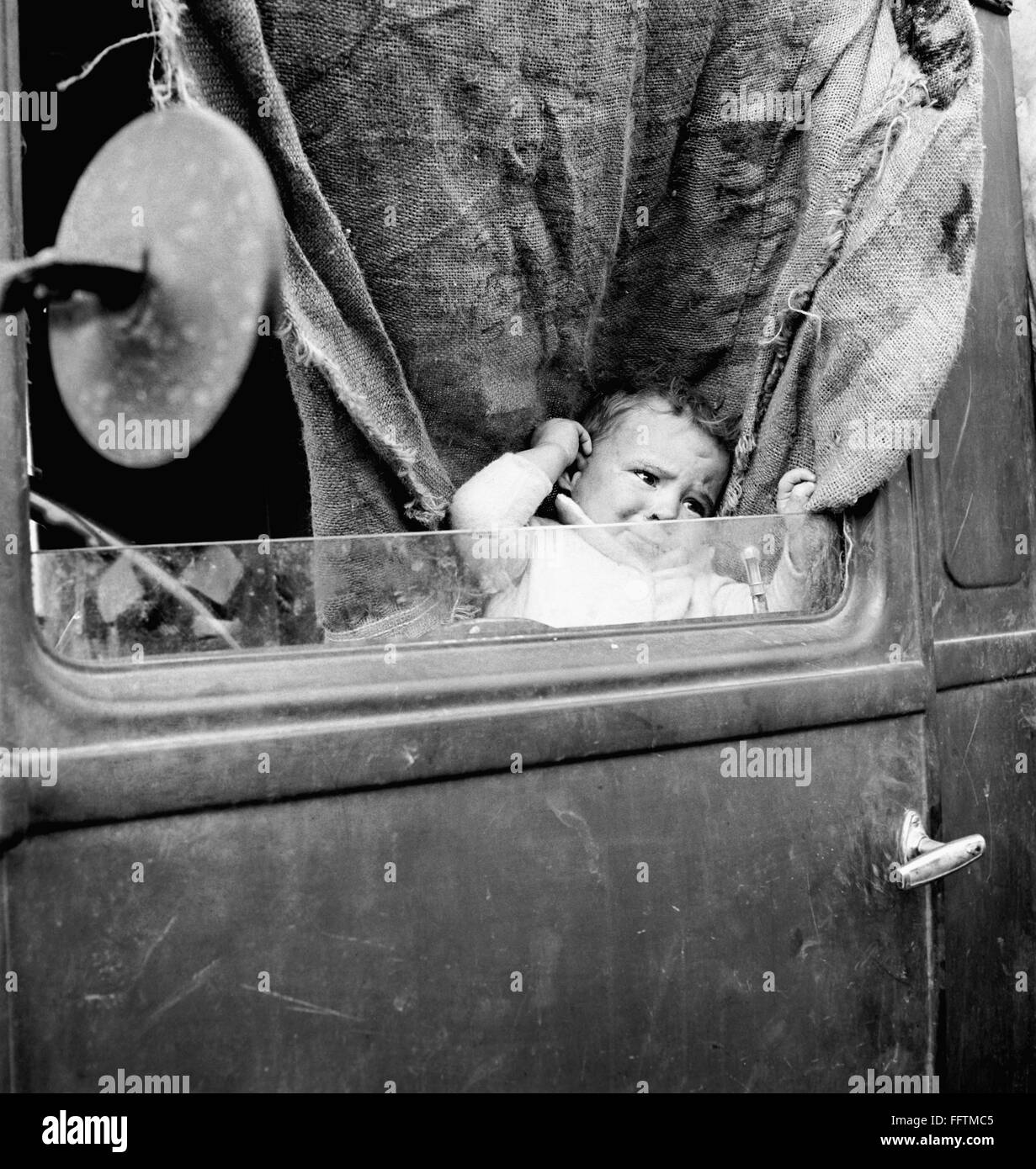 MIGRANT BABY, 1939. /nA baby from Mississippi parked in a truck at a ...