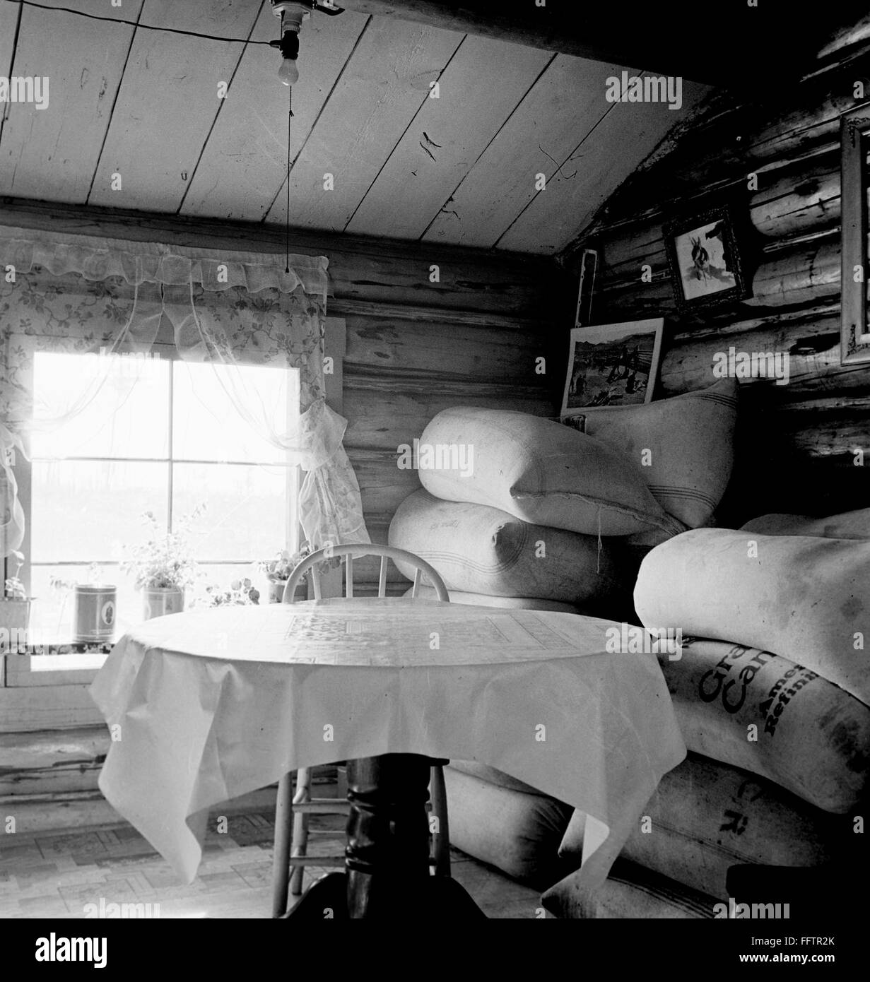 LOG CABIN, 1939. /nInterior of a farmer's two-room log home with ...