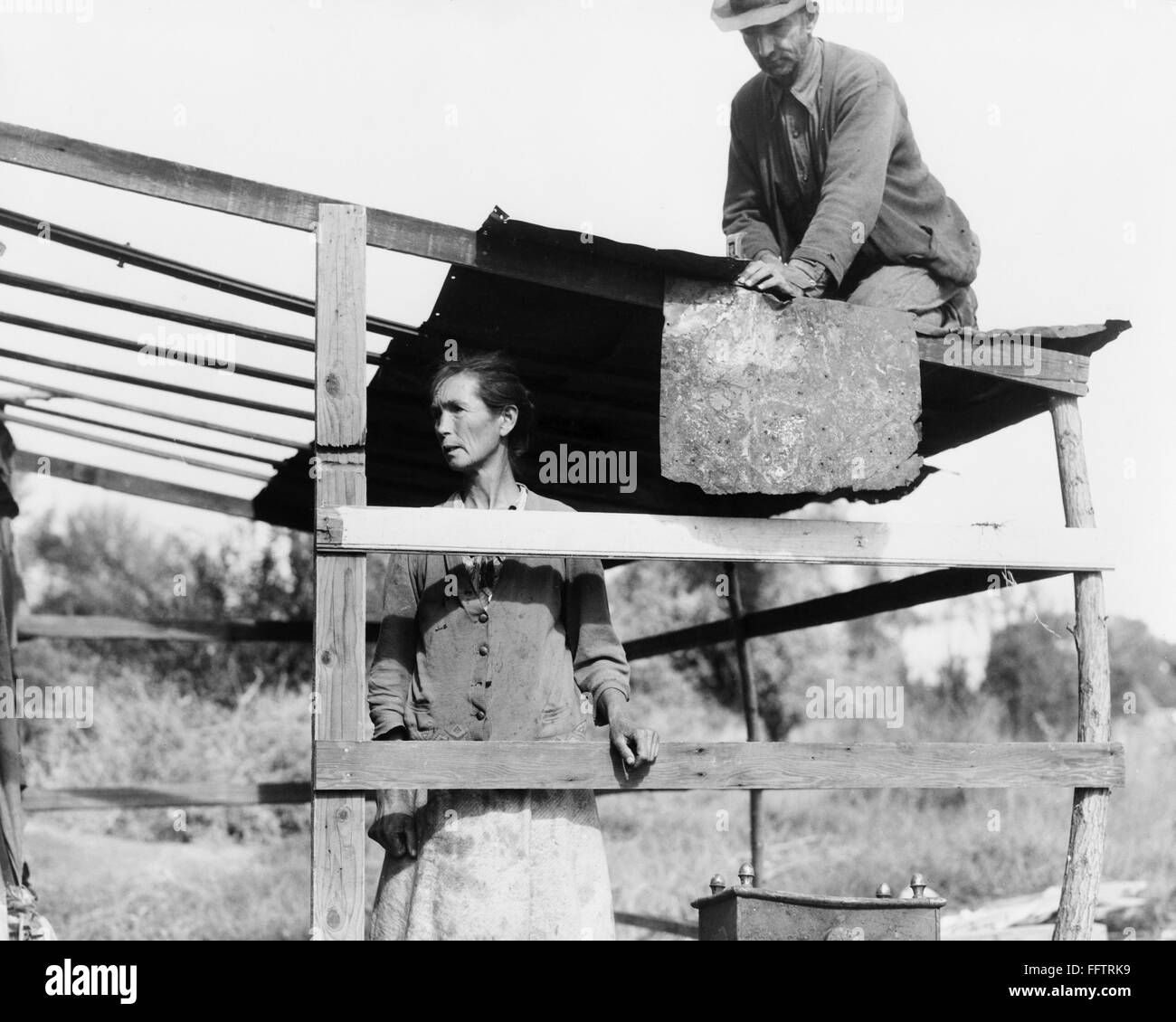 HOMELESS COUPLE, 1935. /nDispossessed Arkansas farmers constructing a ...