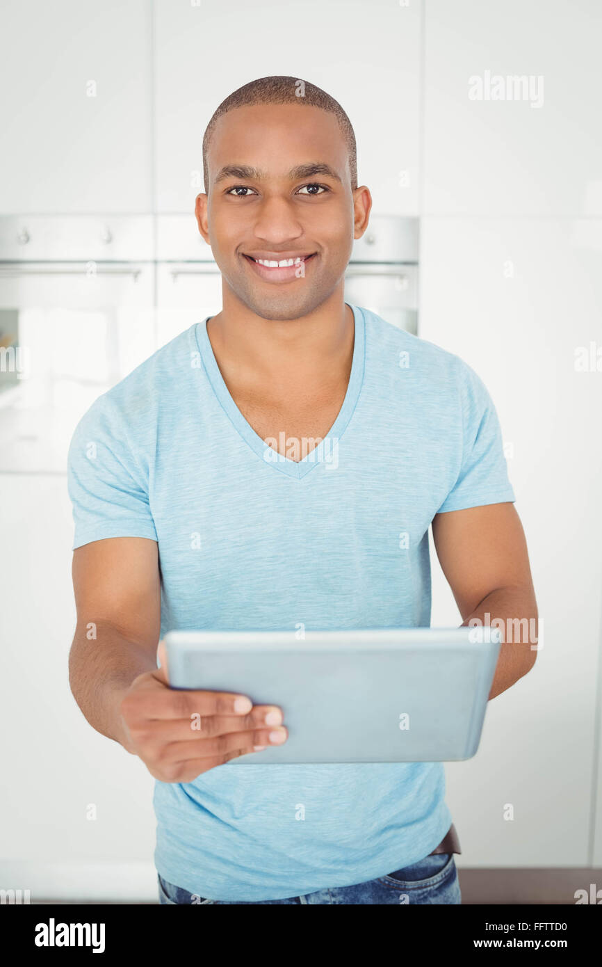 Smiling man using tablet Stock Photo - Alamy
