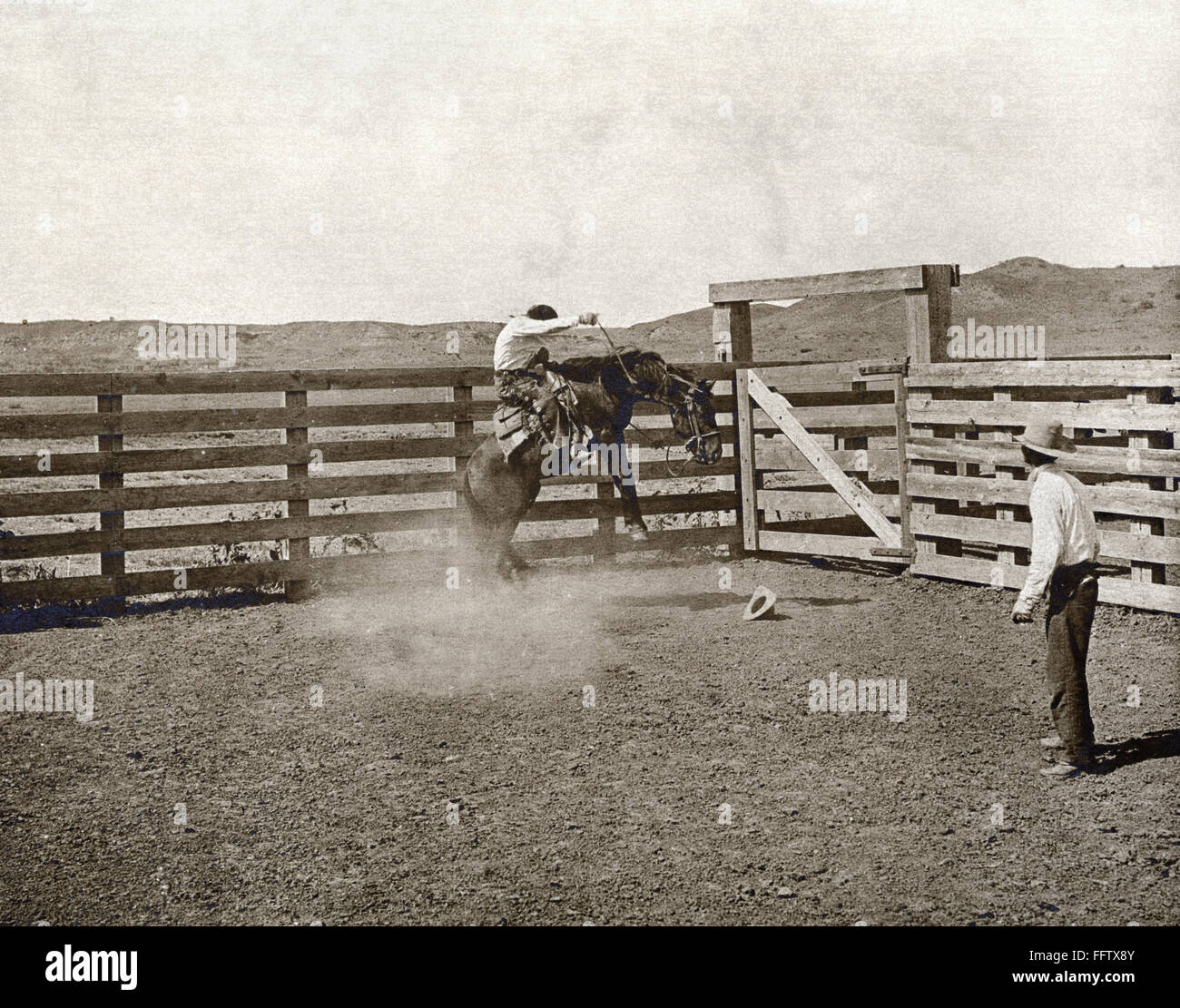 TEXAS: COWBOYS, c1907. /nTwo cowboys breaking a horse in a corral on ...