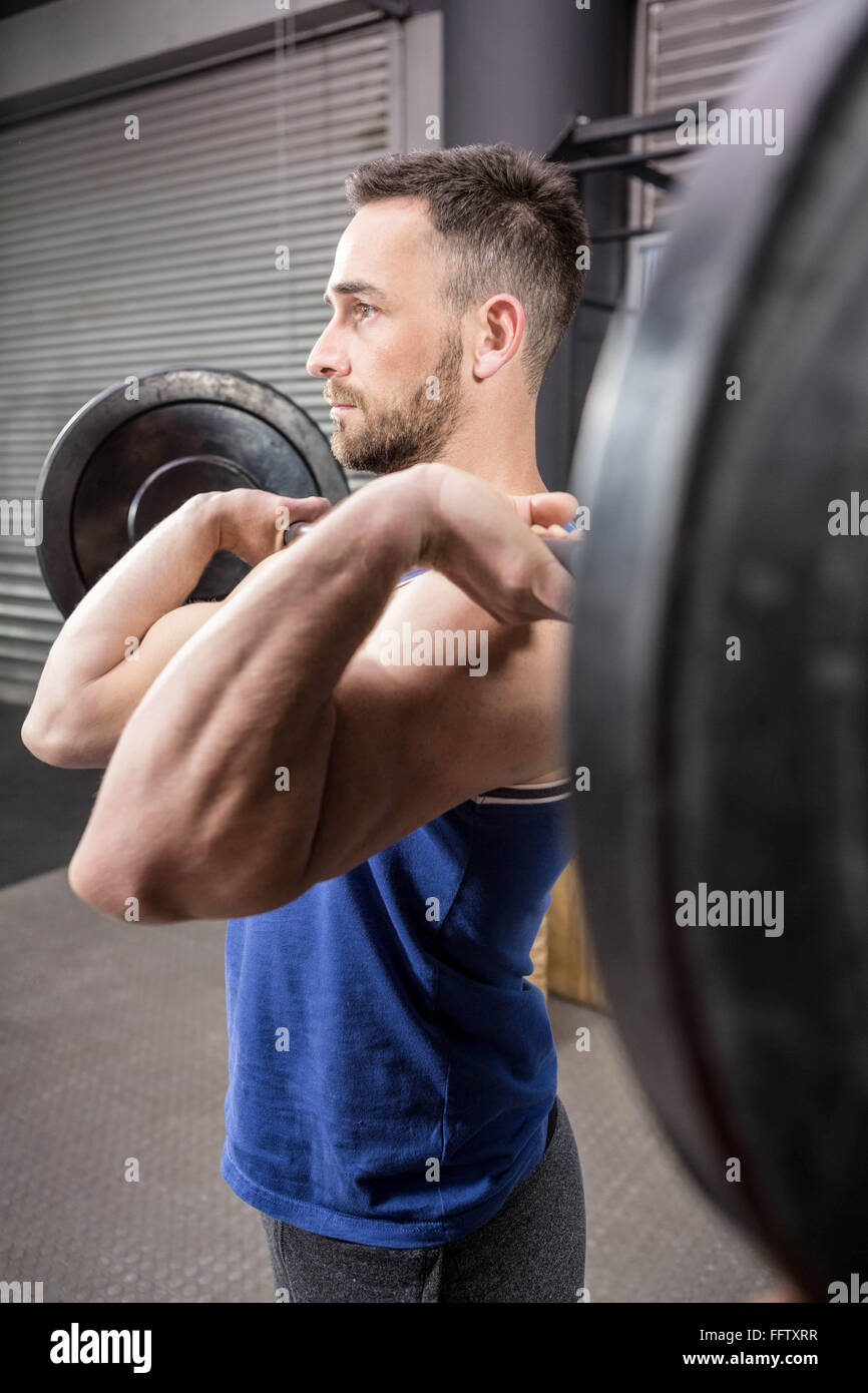 Muscular man lifting barbell Stock Photo - Alamy