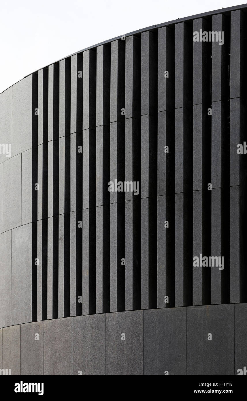 Curved, stone cladding of exterior facade in grey. King's Cross Square ...