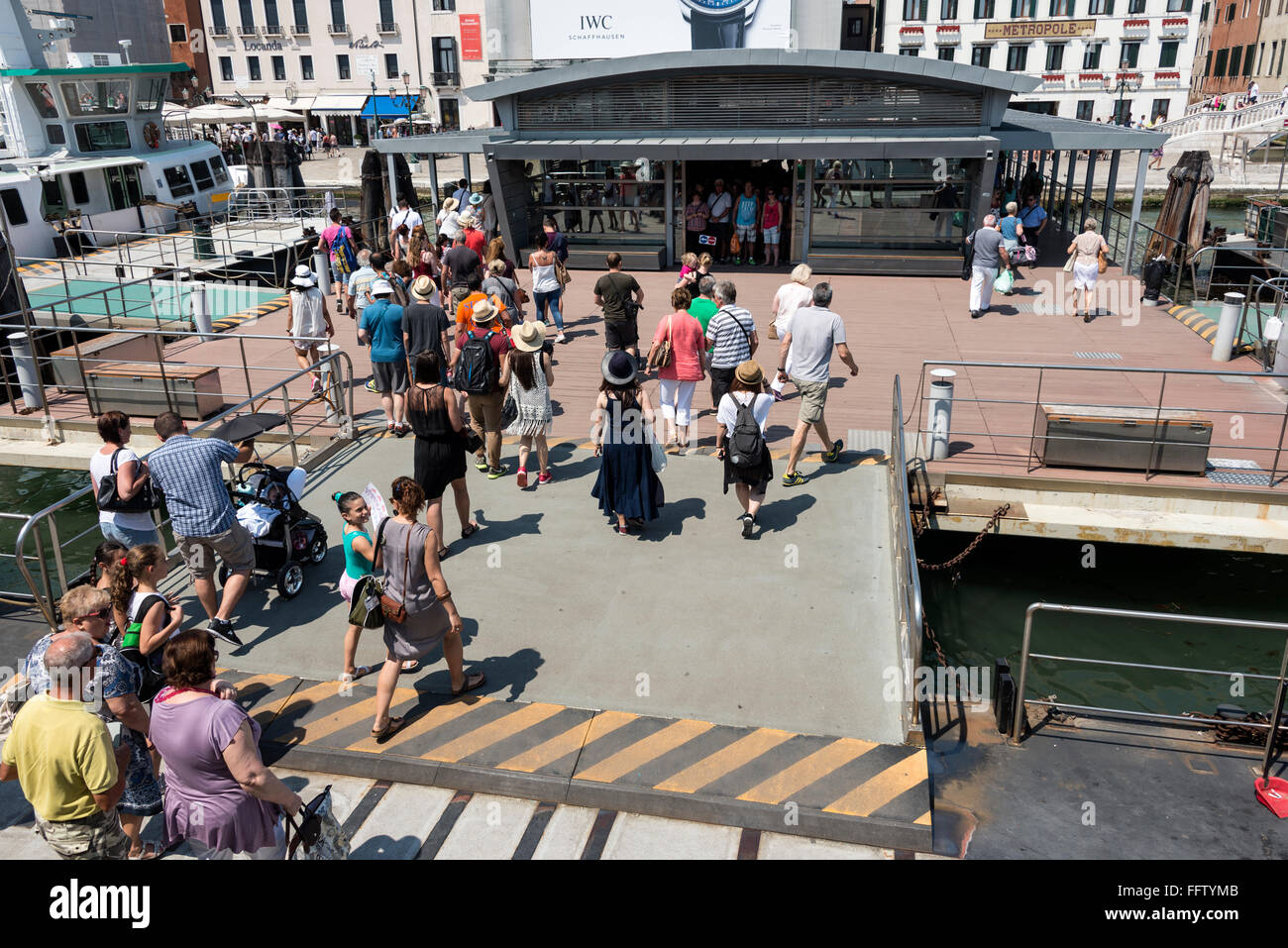 Foot passengers disembarking from the ferry onto the jetty beside the ...