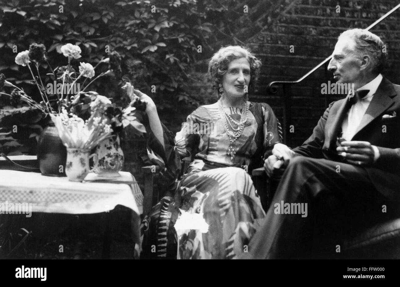 COUPLE. /nAn upper class couple seated outside. Photograph, early 20th ...