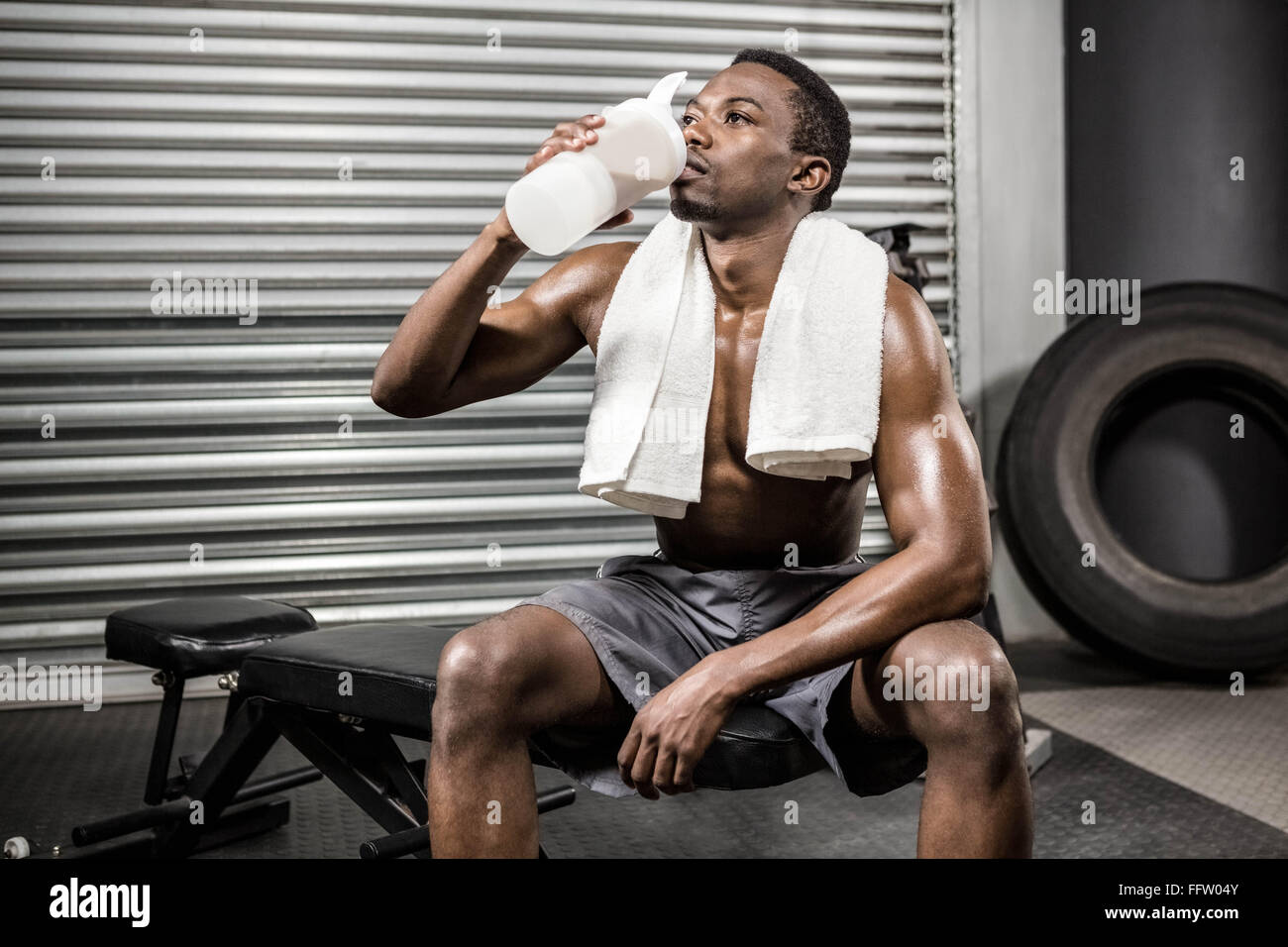 Shirtless man drinking protein shake Stock Photo - Alamy