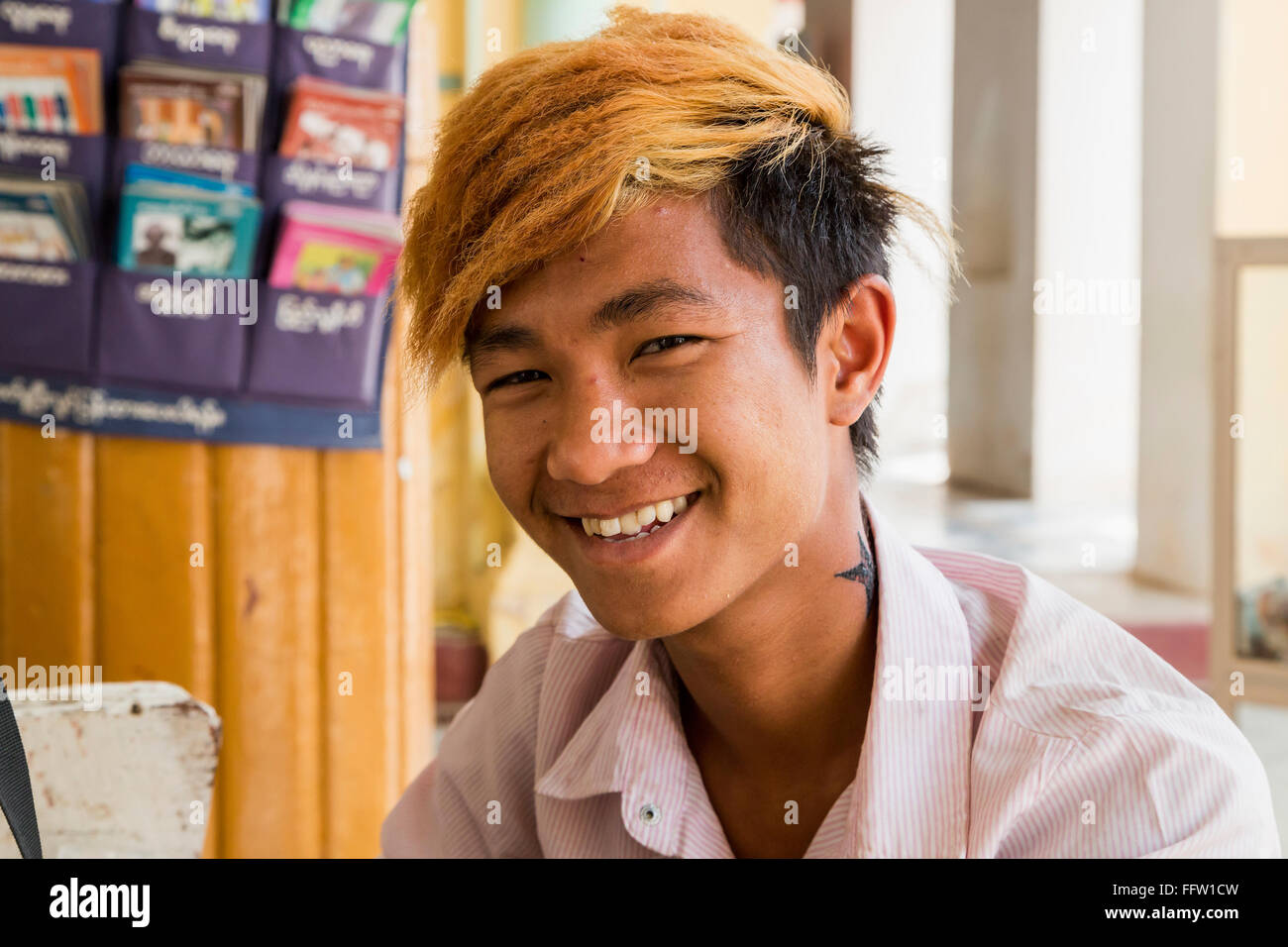BAGAN, Myanmar -15 March 2015: Burmese smiling young man with orange ...