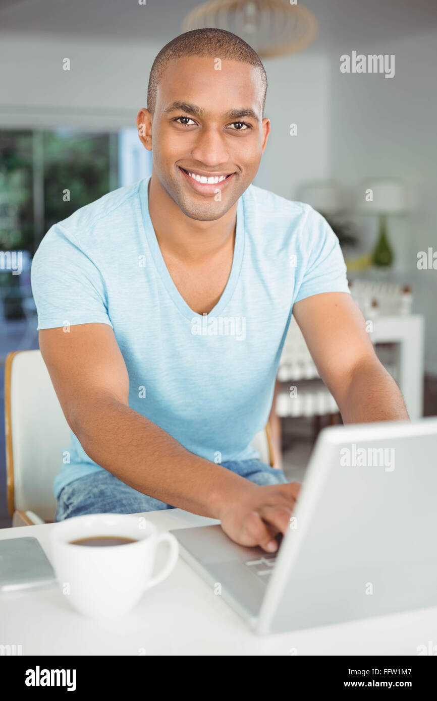 Handsome man using laptop Stock Photo - Alamy