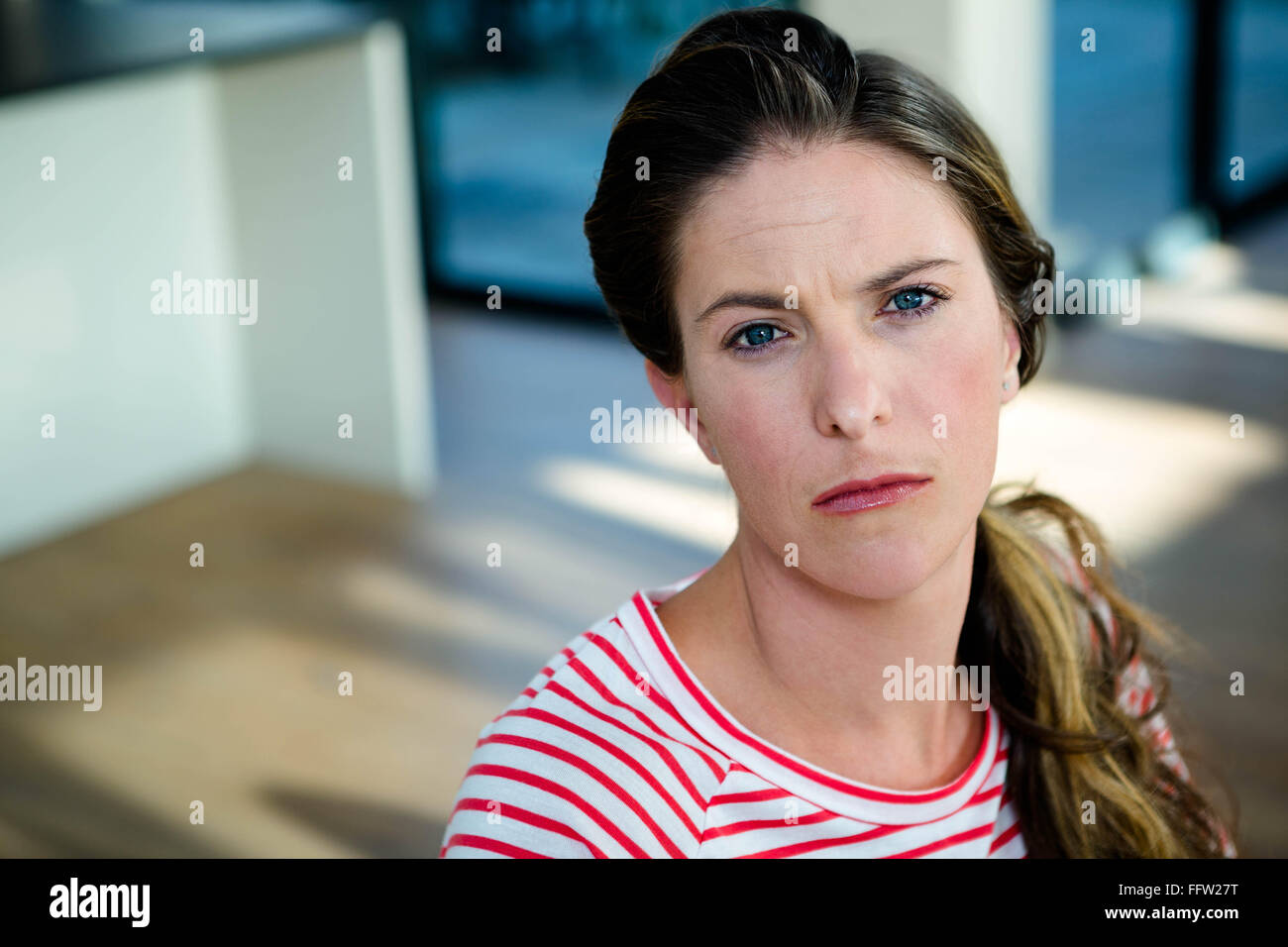 woman staring into the camera unhappily Stock Photo - Alamy