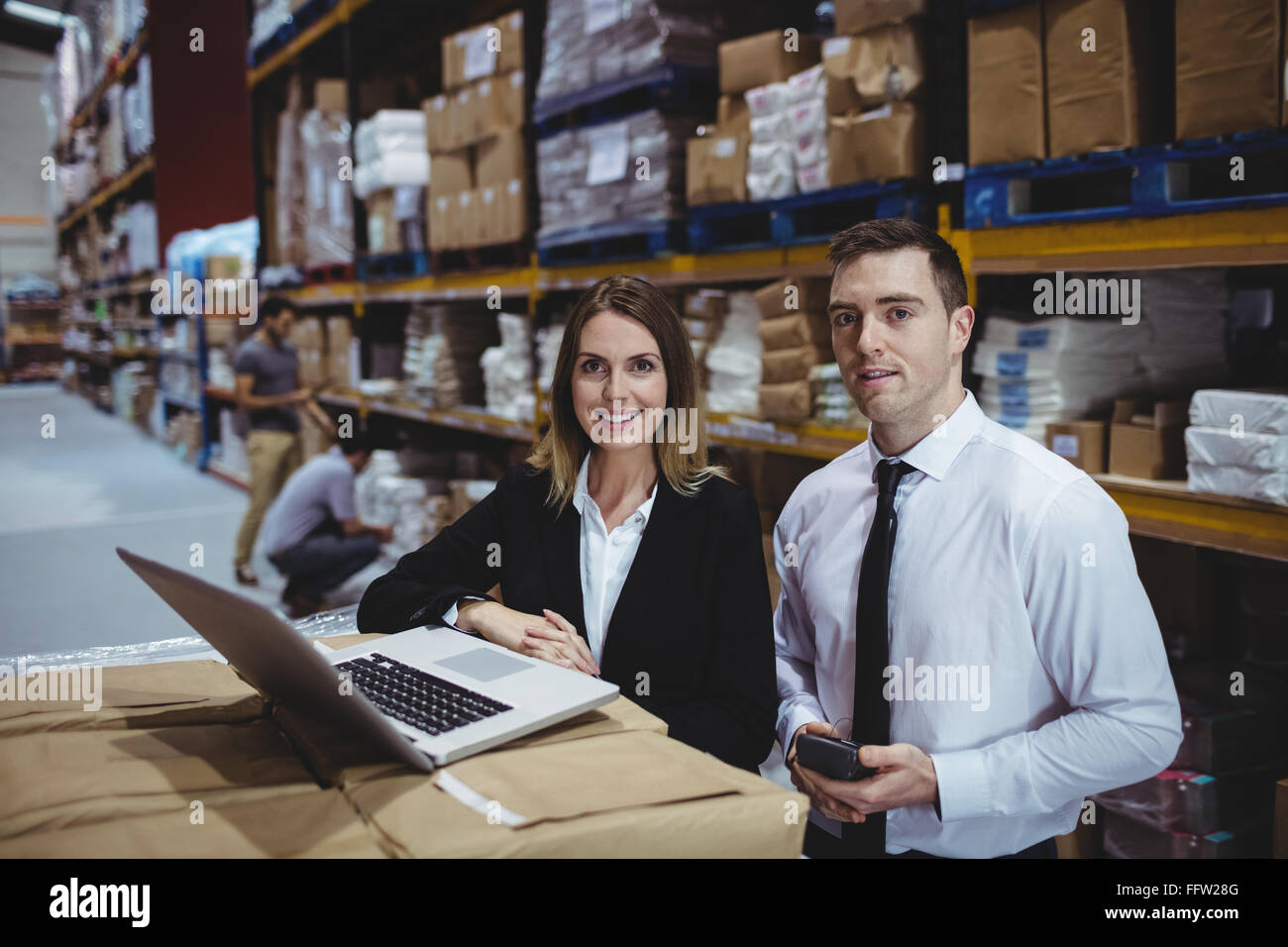 Warehouse managers using laptop Stock Photo - Alamy