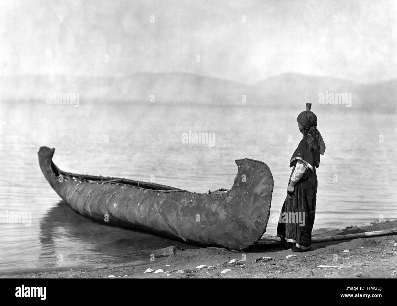 KUTENAI WOMAN, c1910. /nA young Kutenai woman standing beside a canoe ...