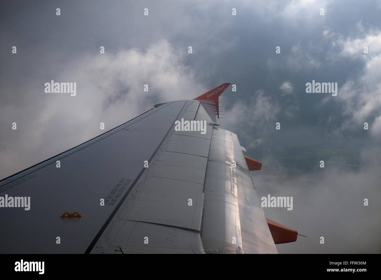 Easyjet wing tip in flight through clouds Stock Photo - Alamy