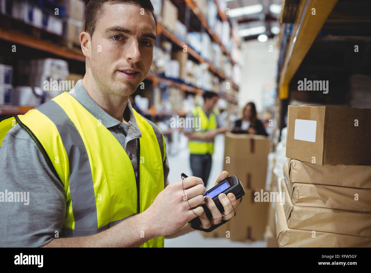 Warehouse worker scanning box Stock Photo - Alamy