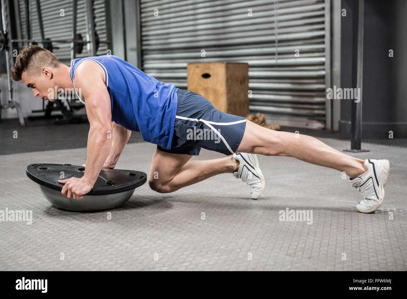 Muscular man doing push up on bosu ball Stock Photo - Alamy