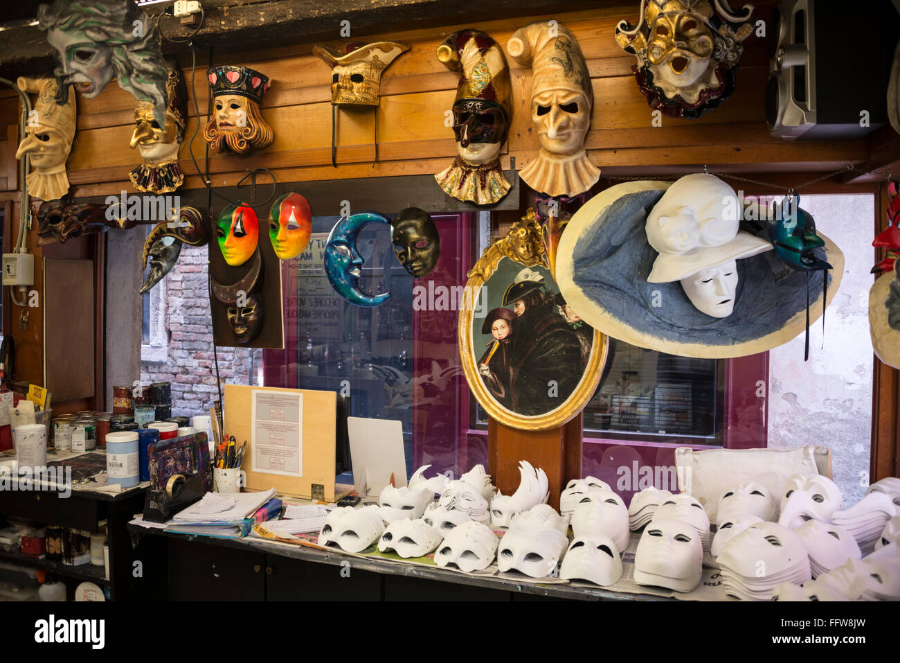 A window display of facemasks in a handmade mask-making shop/art studio ...