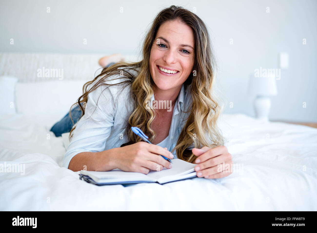 Woman writing diary bed hi-res stock photography and images - Alamy