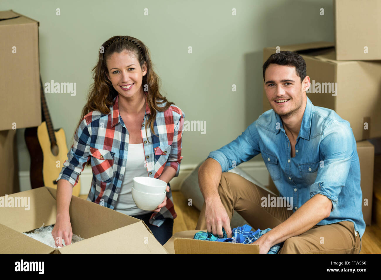 Young couple unpacking carton boxes Stock Photo - Alamy