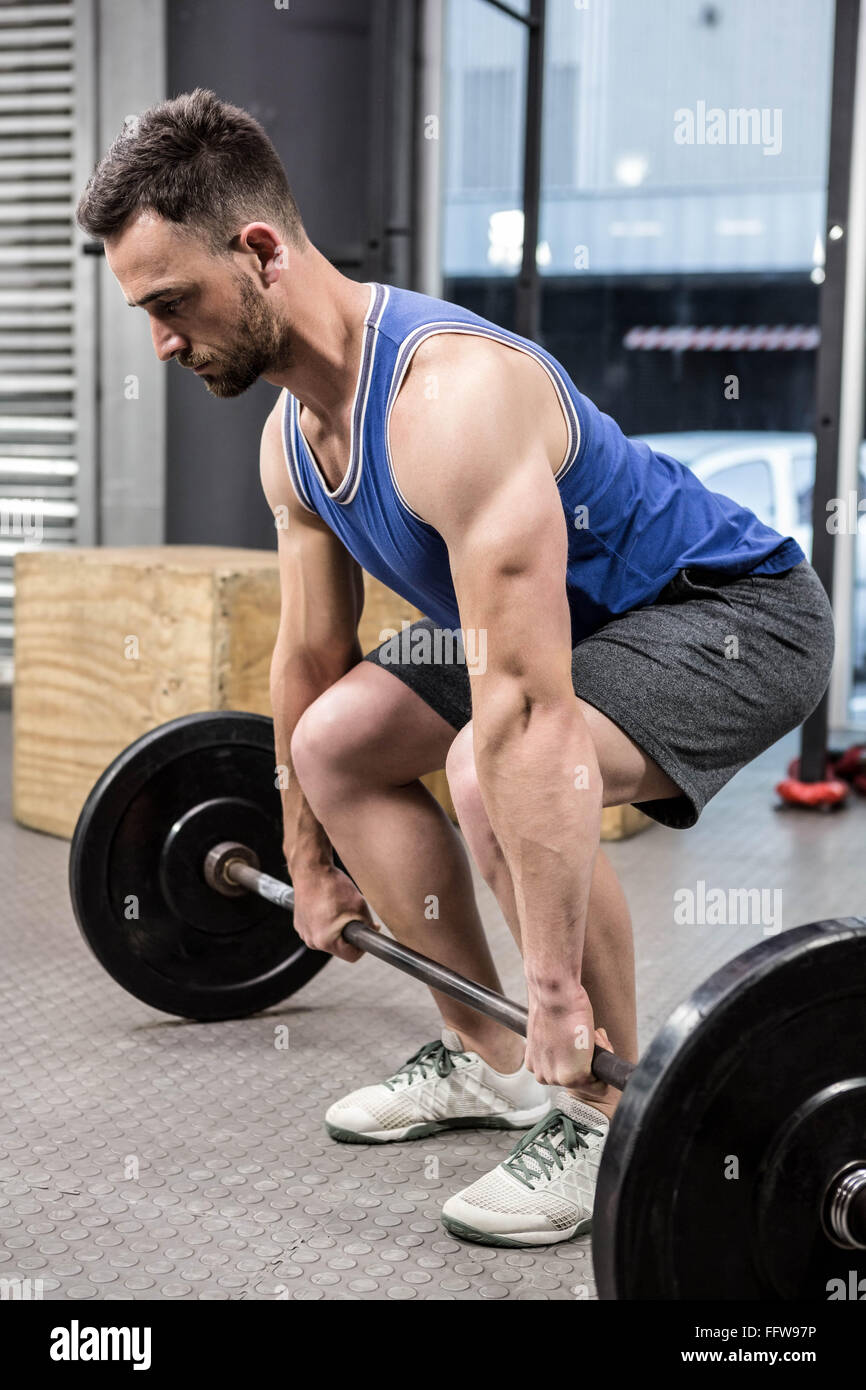 Muscular man lifting barbell Stock Photo - Alamy