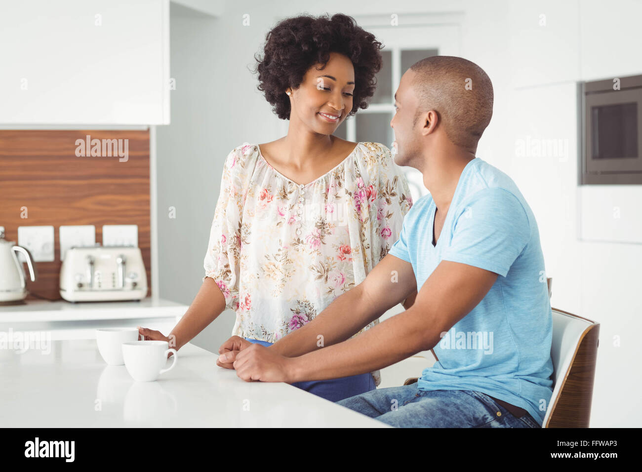 Smiling couple talking Stock Photo - Alamy