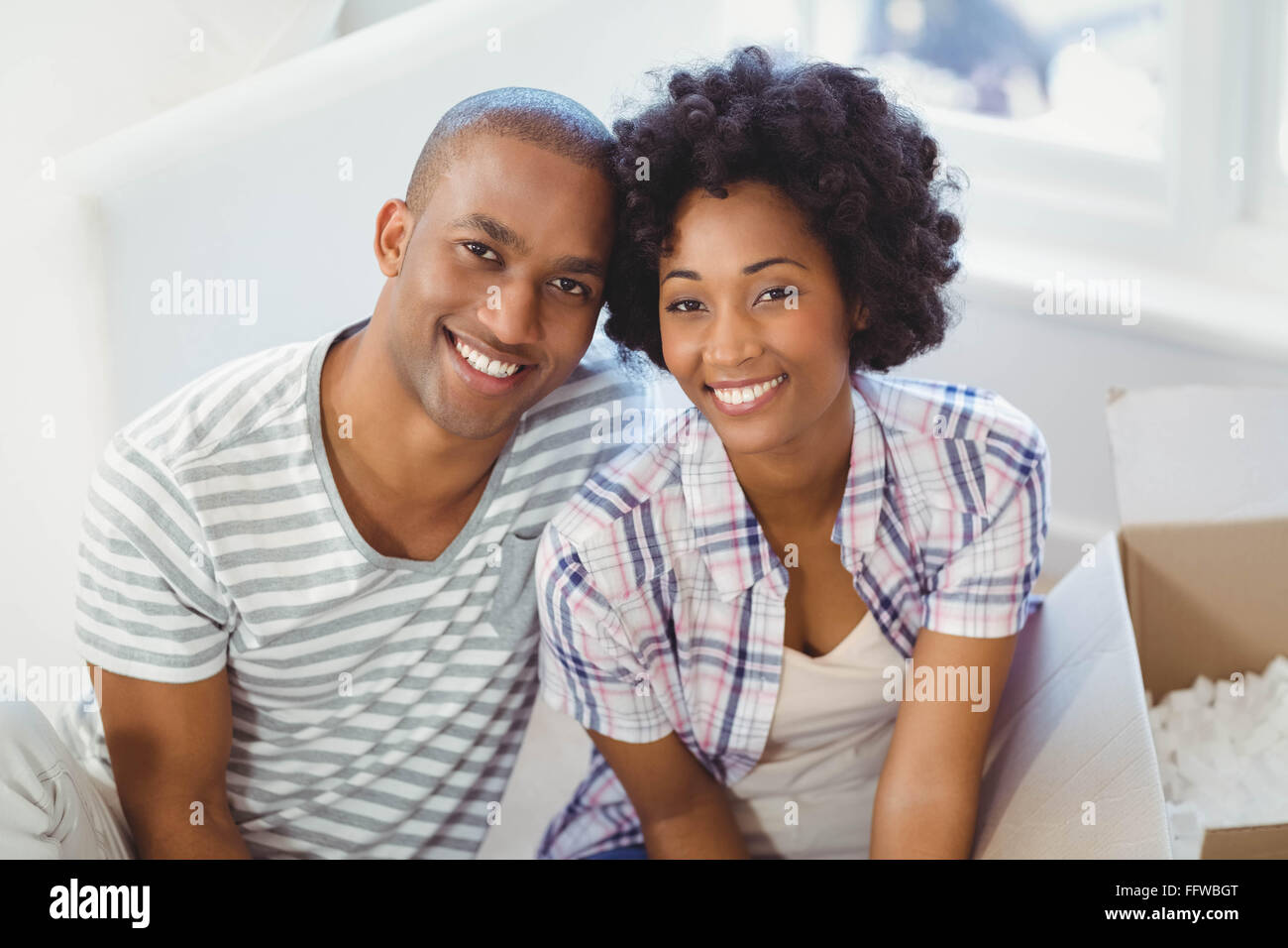 Happy couple opening boxes Stock Photo - Alamy