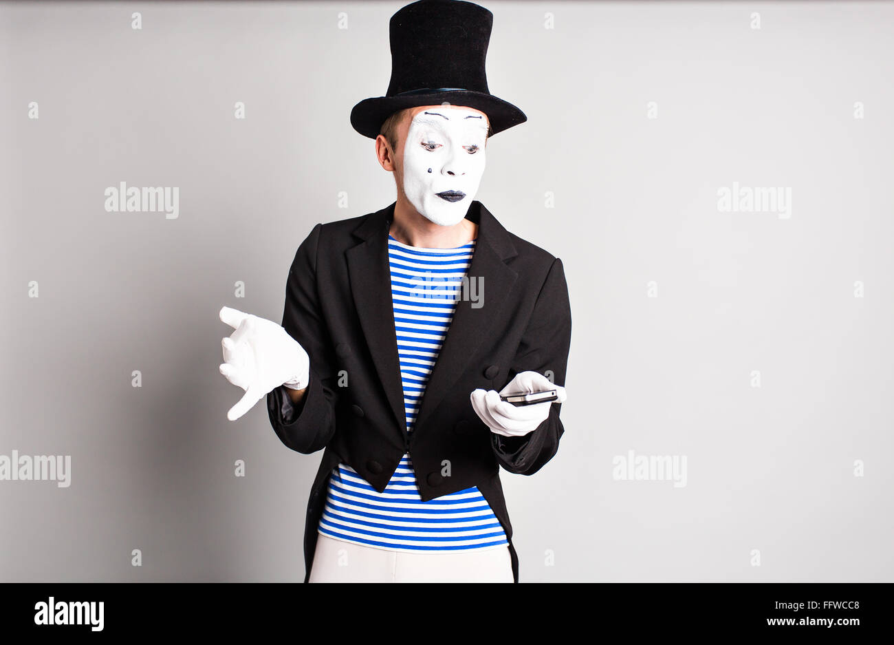 mime with smartphone. Concept of April Fools Day Stock Photo - Alamy