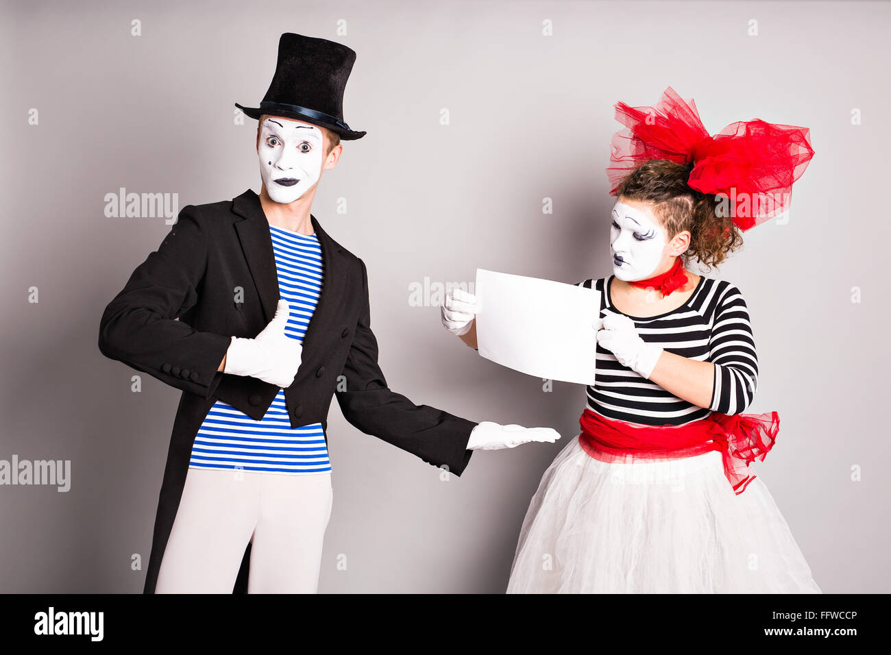 Two mimes with a sign for advertising, April Fools Day concept Stock ...