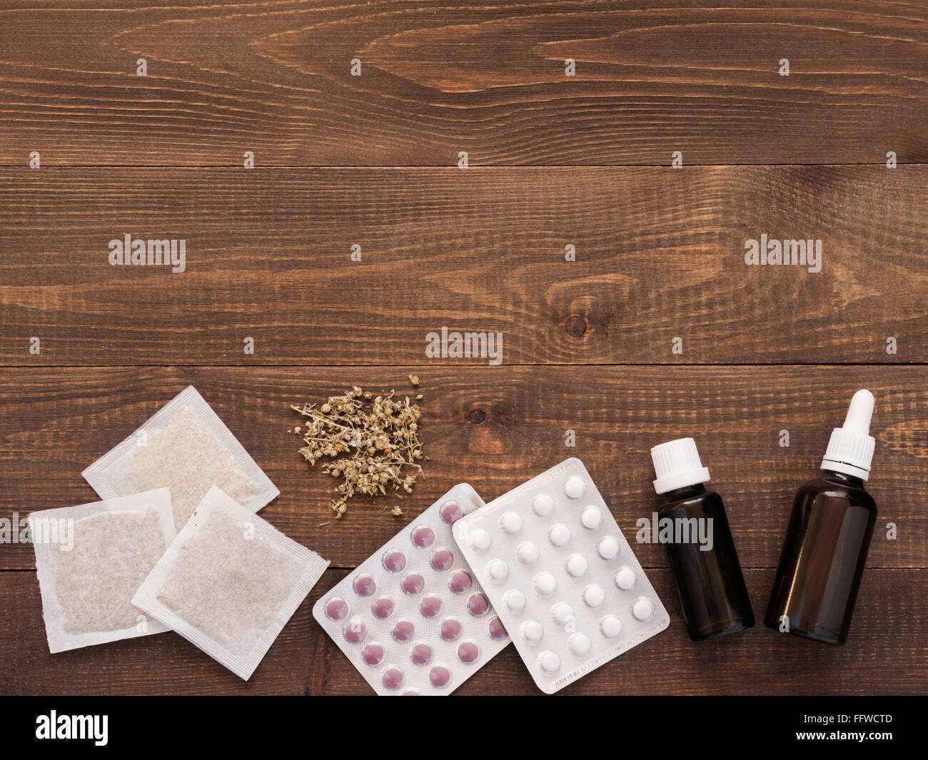 tablets, drops and herbals on a dark wooden background Stock Photo - Alamy