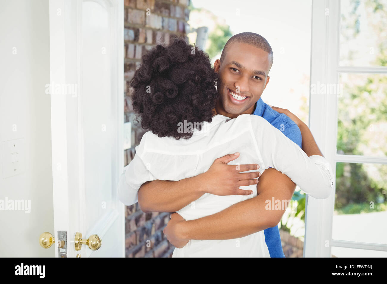 Romantic couple hugging door man hi-res stock photography and images ...