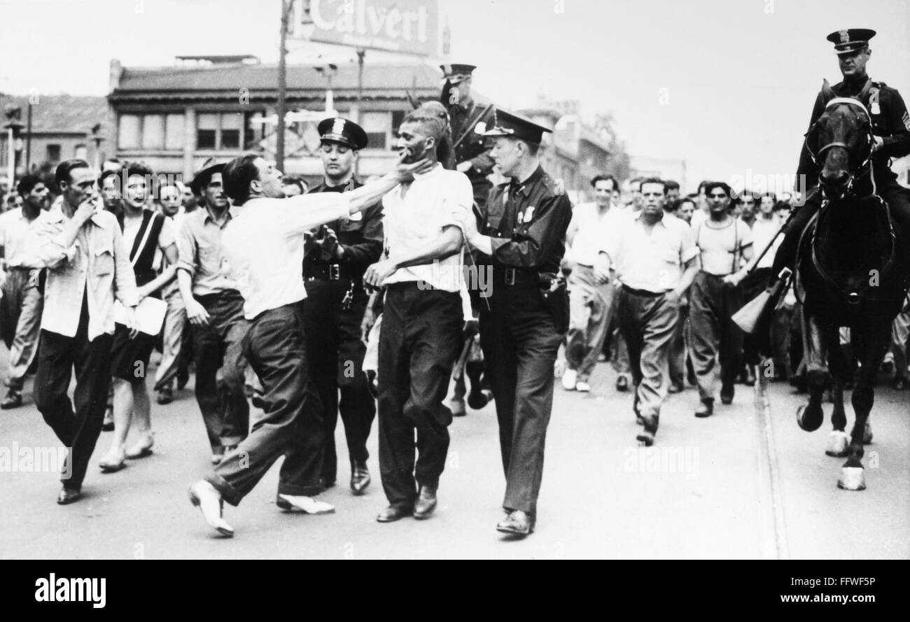 DETROIT RIOT, 1943. /nPolice officers half-heartedly protecting a black ...