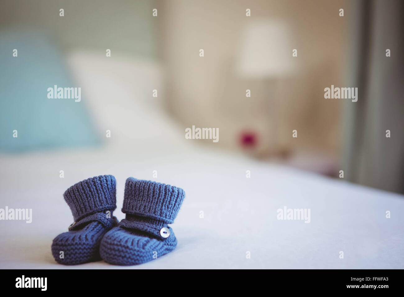 View of baby shoes on a bed Stock Photo - Alamy