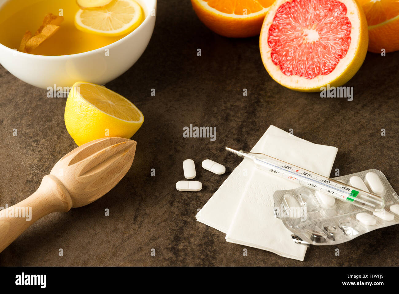 Vitamins from fruit pills and hot tea against flu Stock Photo - Alamy