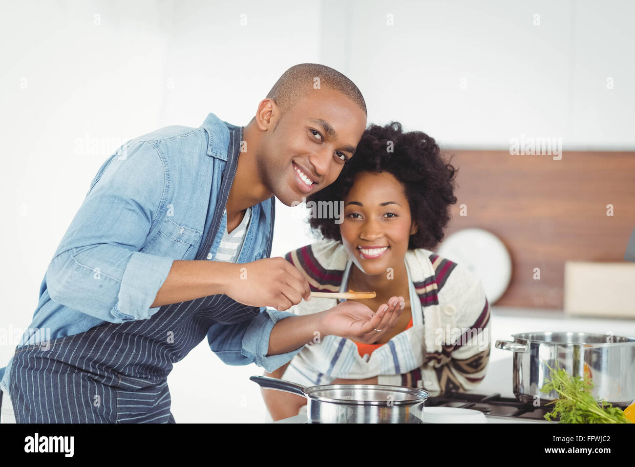 Cheerful black couple cooking hi-res stock photography and images - Alamy
