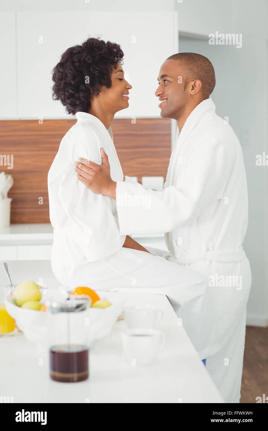 Happy couple hugging in the kitchen Stock Photo - Alamy