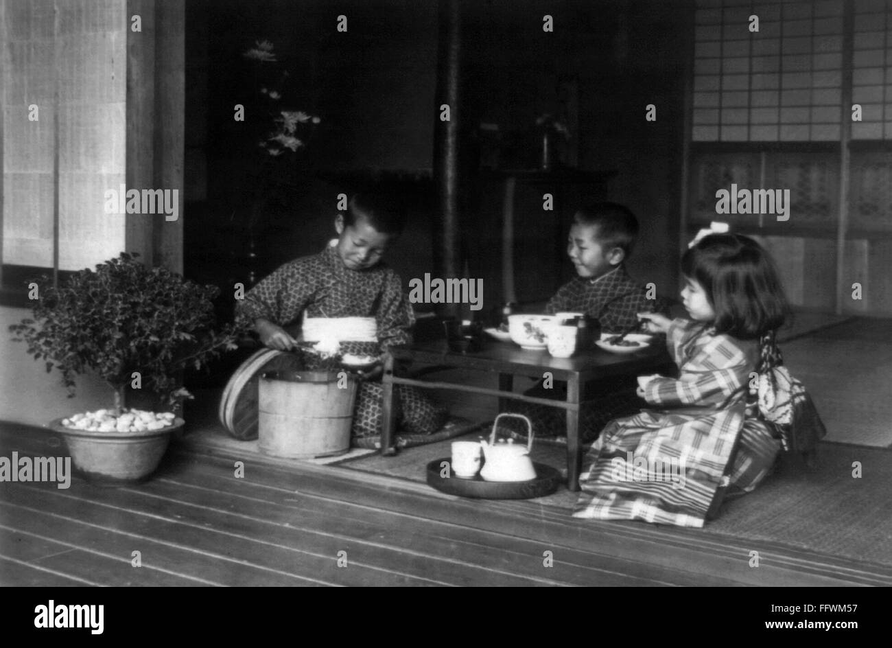 JAPAN: TEA PARTY. /nThree children having a tea party around a table in ...