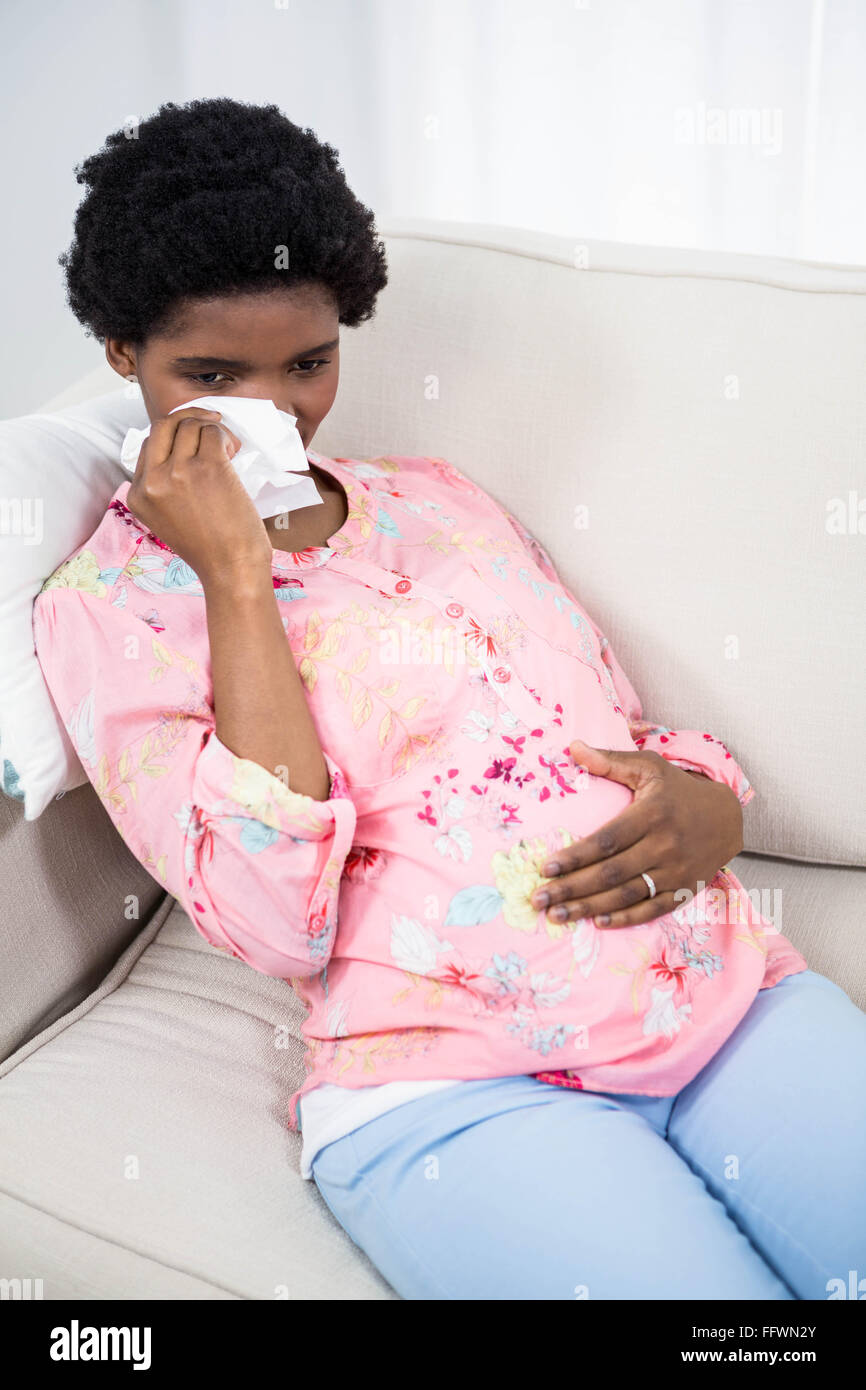 Sad pregnant woman relaxing on sofa Stock Photo - Alamy