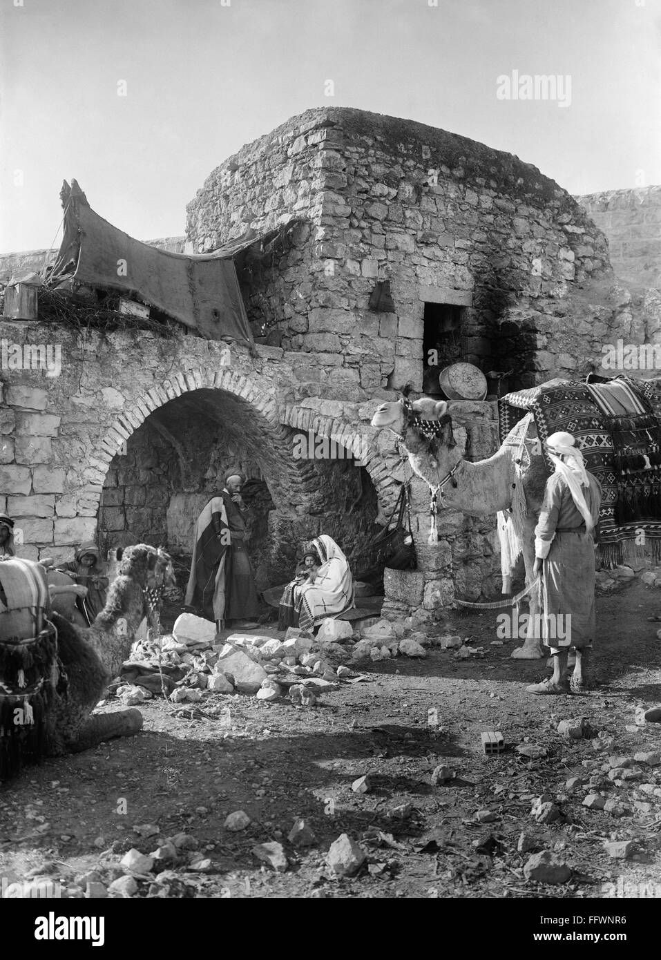 BETHLEHEM: HOME, c1928. /nA family with camels outside a stone home in ...