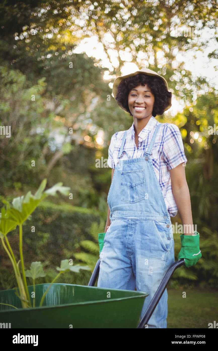 Woman pushing wheelbarrow hi-res stock photography and images - Alamy