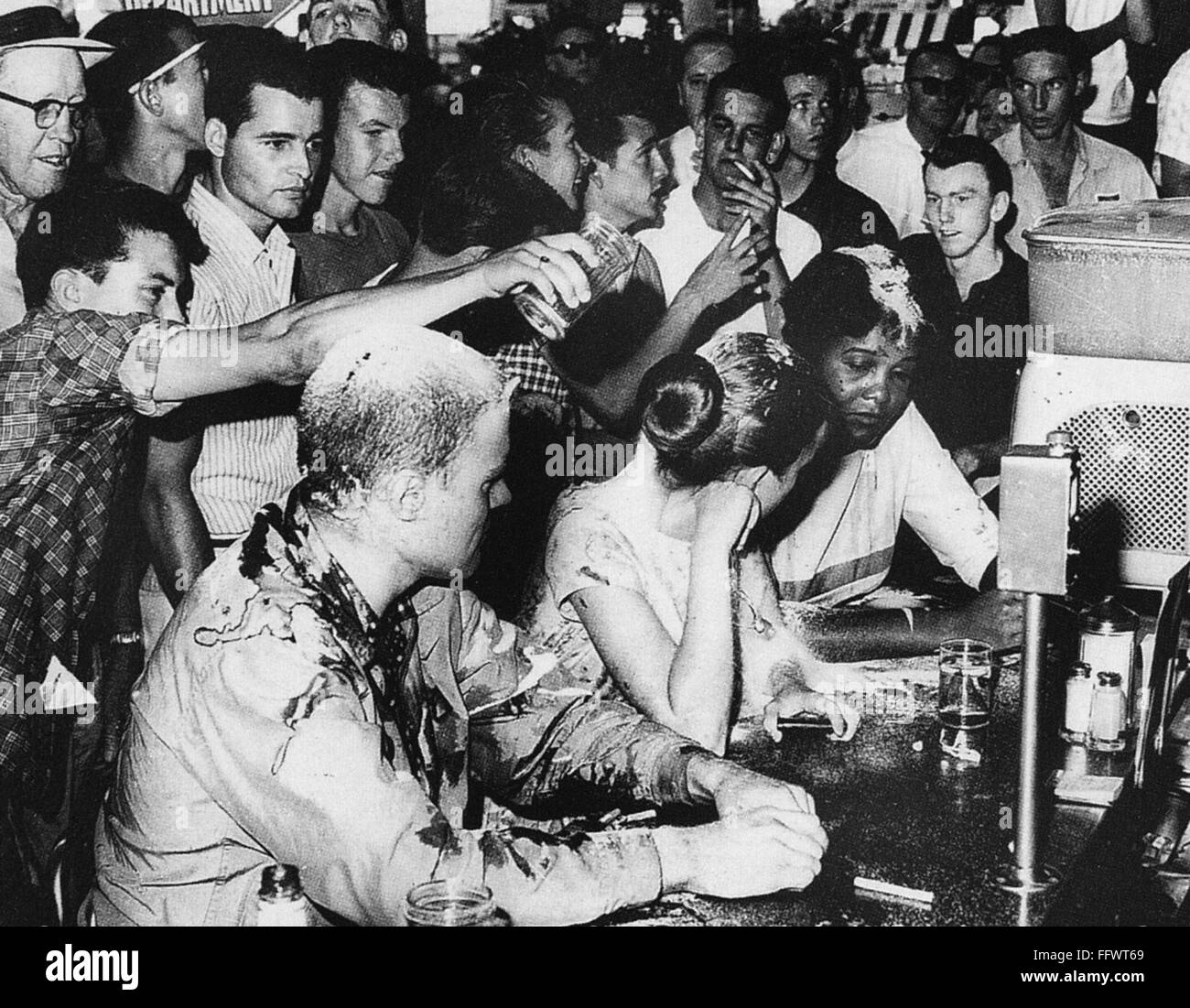 LUNCH COUNTER SIT-IN, 1963. /nThree demonstrators at a lunch counter ...