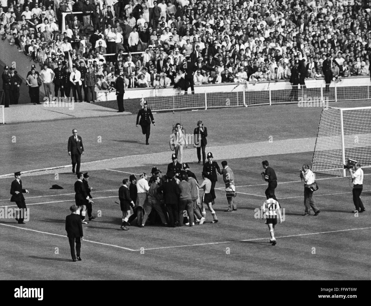 WORLD CUP, 1966. /nPolice officers rush on to the field at Wembley ...