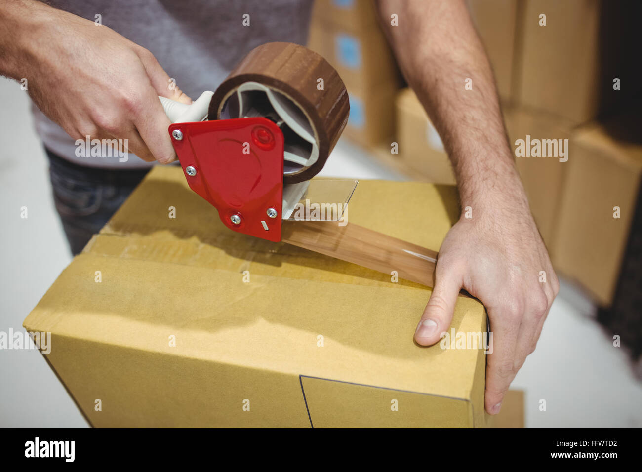 Man taping box Stock Photo - Alamy