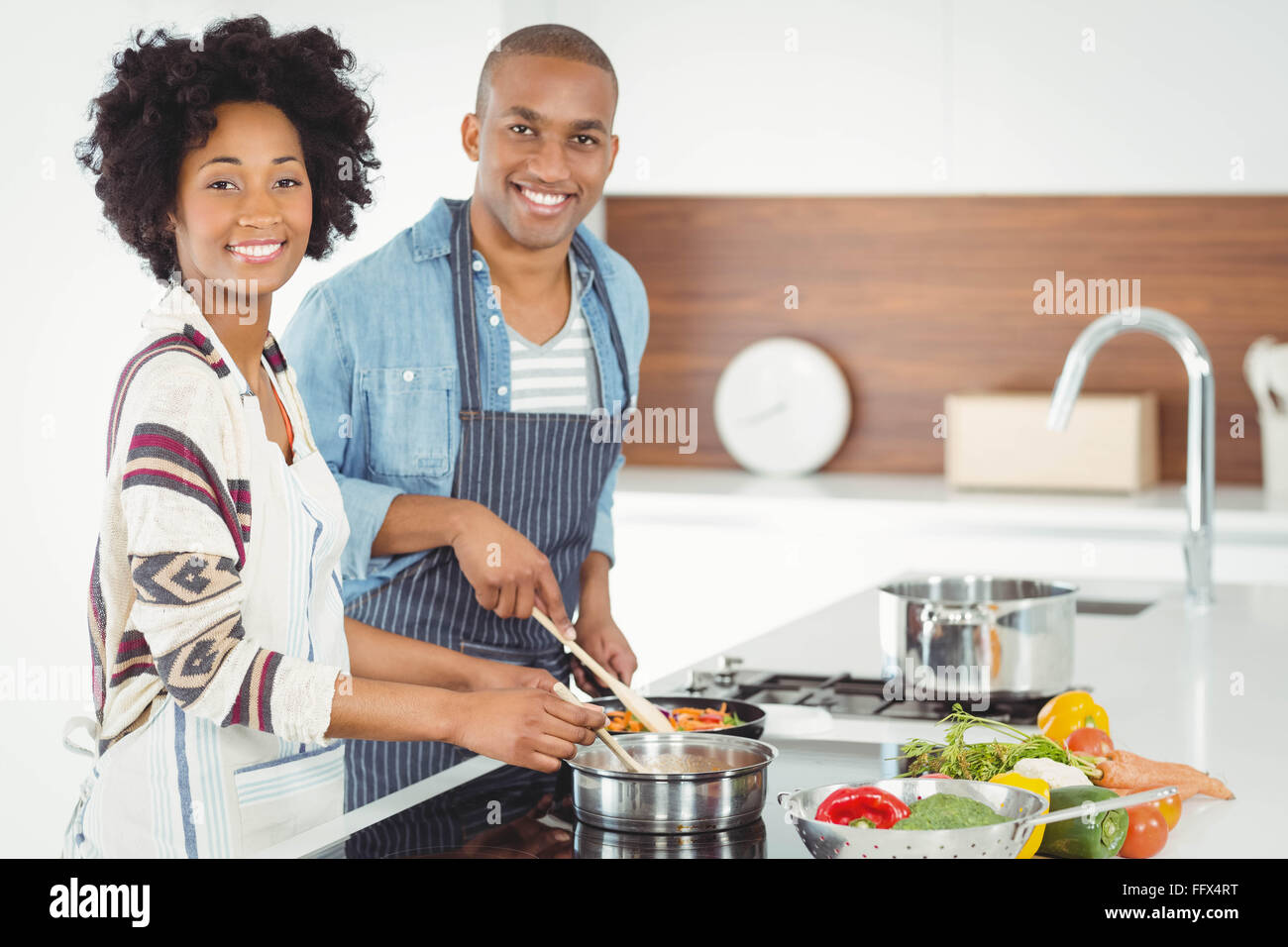 Happy couple cooking together Stock Photo - Alamy