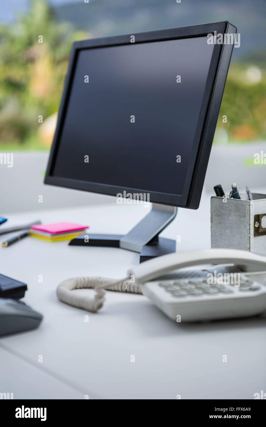 Computer and telephone on desk Stock Photo - Alamy